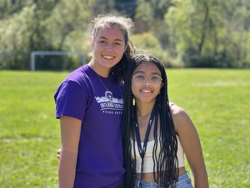 Two International School students smiling outside