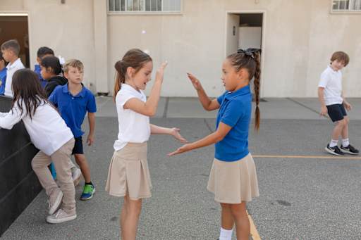 hands holding school