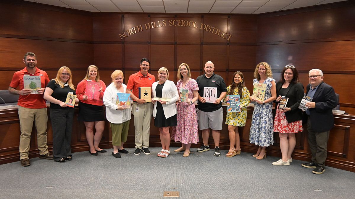 School board donates books in honor of retiring secretary Lori Rieger ...